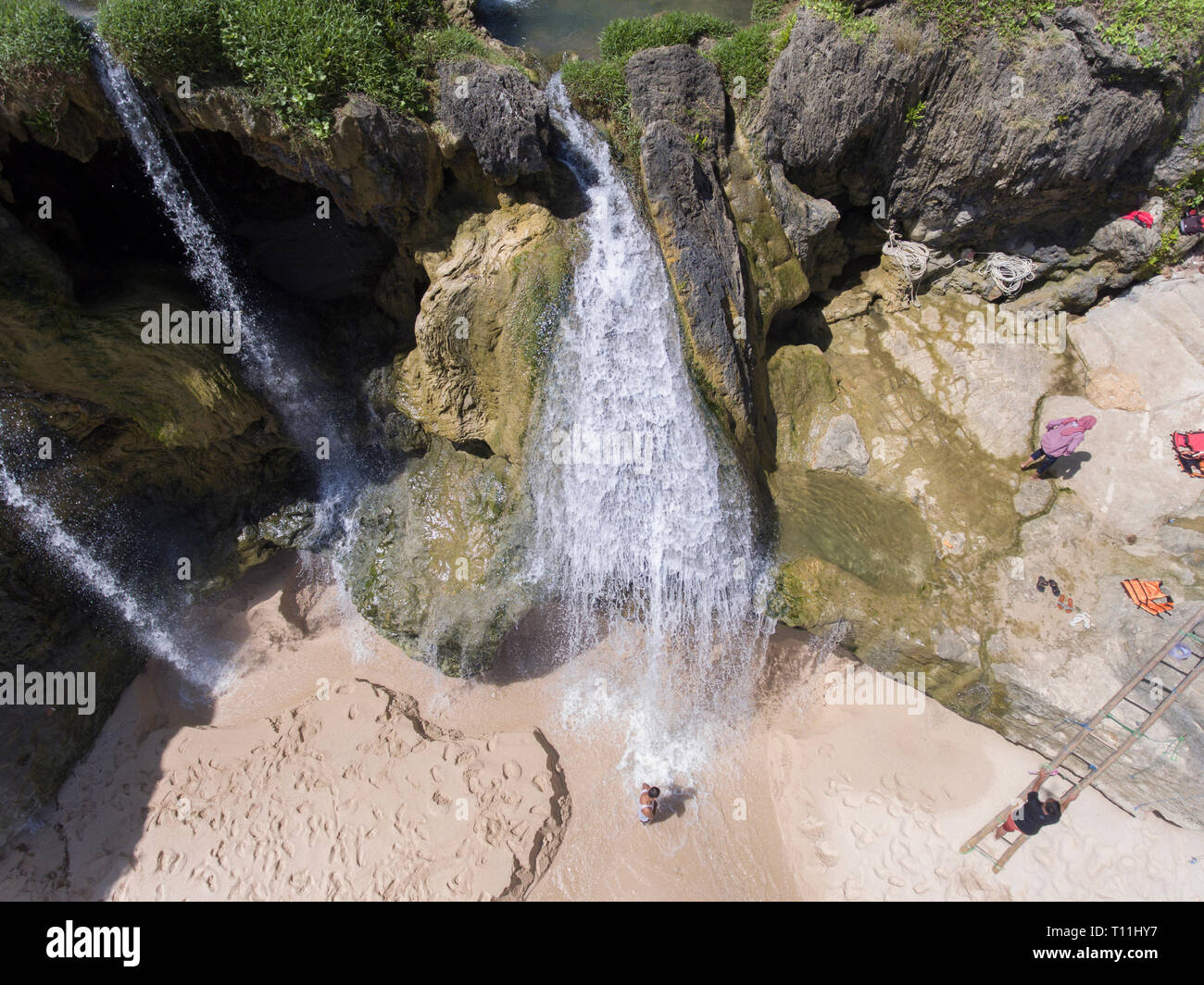 A man take a bath in waterfall and use it as a shower. The waterfall ...