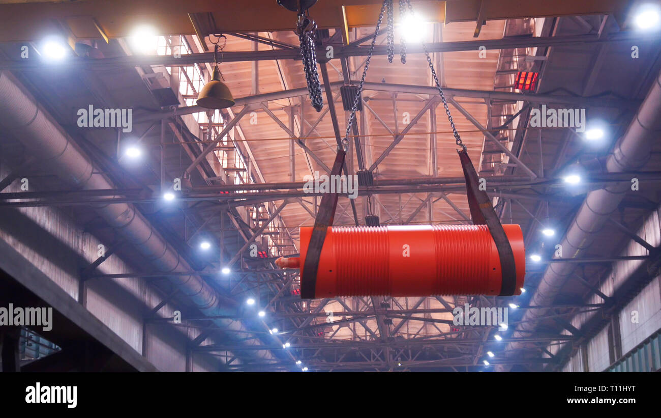 Industrial concept. A crane lifting on a big detail for constructing ...