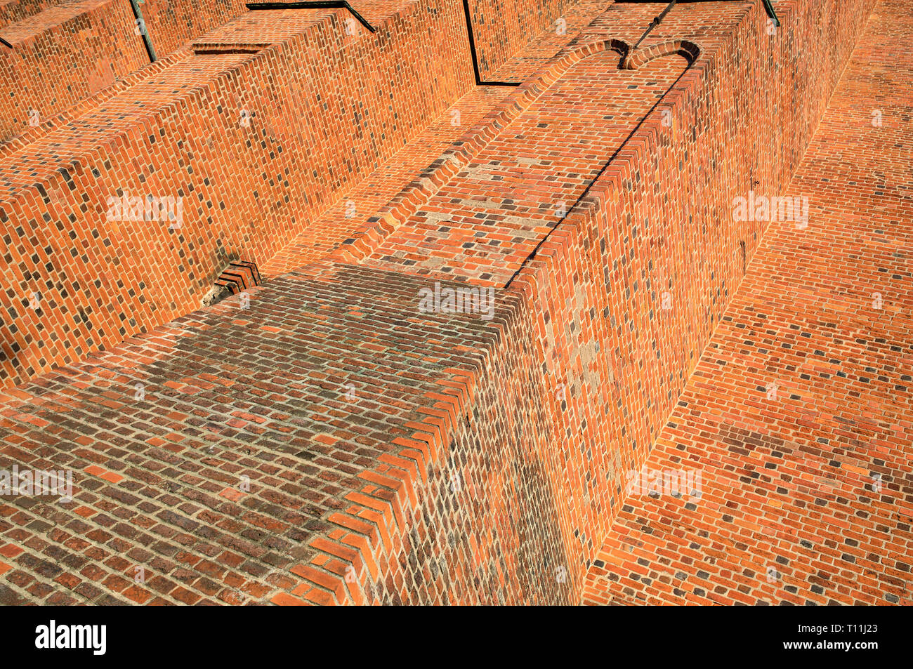 Bricks, red gothic medieval wall, Cathedral in Gniezno, Poland. View to ...