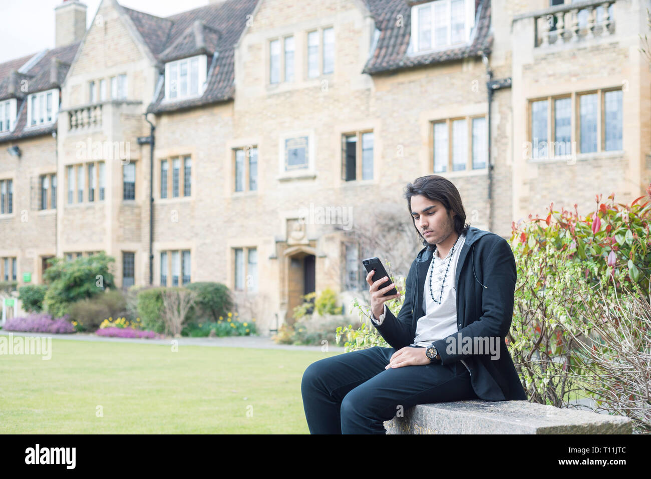 A confident male Middle Eastern international student in the square of ...