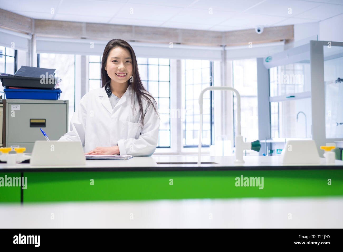 A young South East Asian student works during a lesson and carries out ...