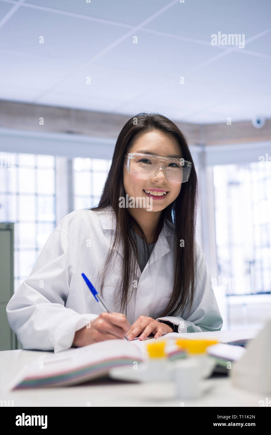 A young South East Asian student works during a lesson and carries out ...