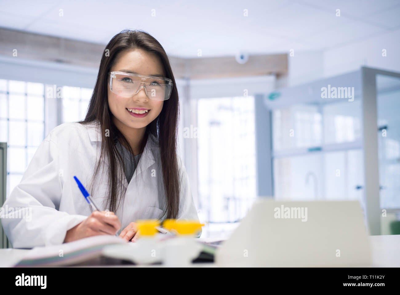 A young South East Asian student works during a lesson and carries out ...
