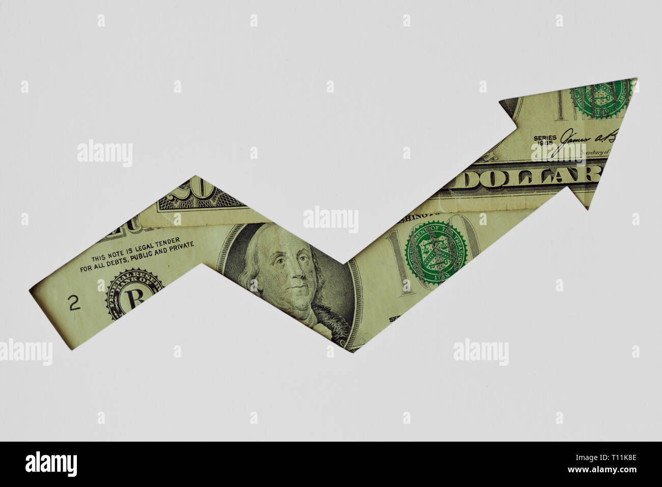 Upward arrow made of dollar banknotes on white background - Concept of ...