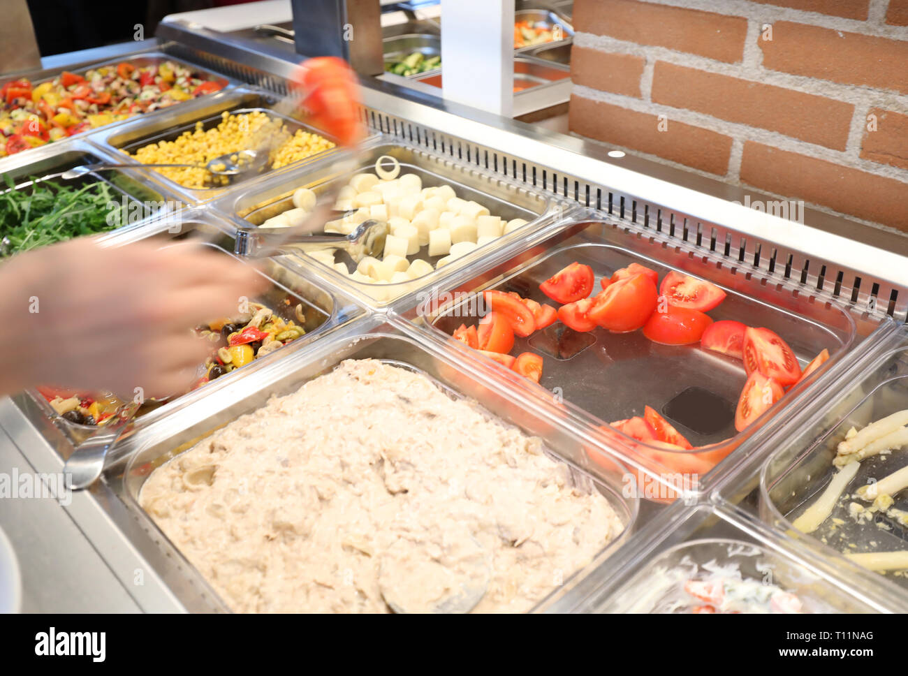 Inside a self service restaurant with many raw and cooked foods Stock ...