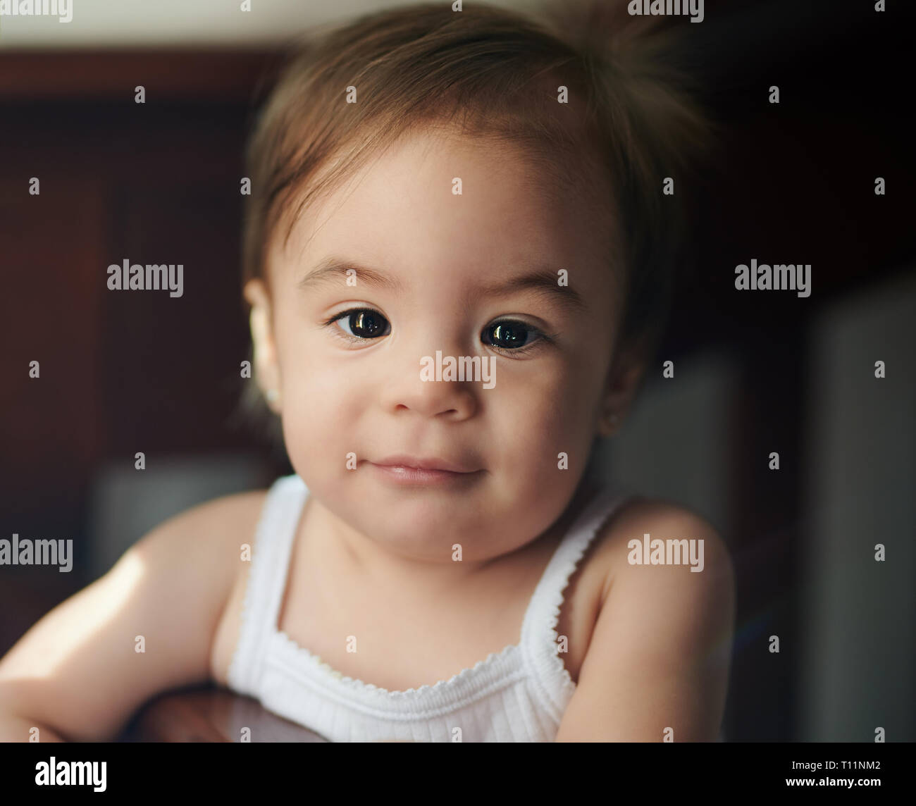 Close-up portrait of baby girl in home indoor background Stock Photo ...