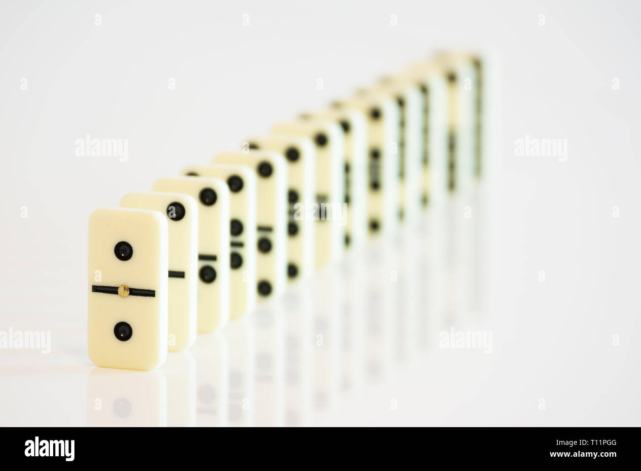 domino tiles in a row on a white background Stock Photo - Alamy