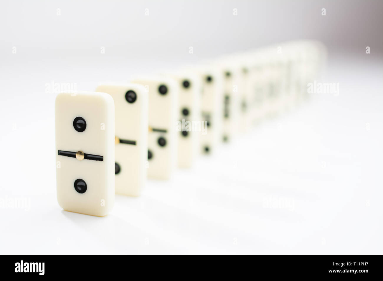 domino tiles in a row on a white background Stock Photo - Alamy