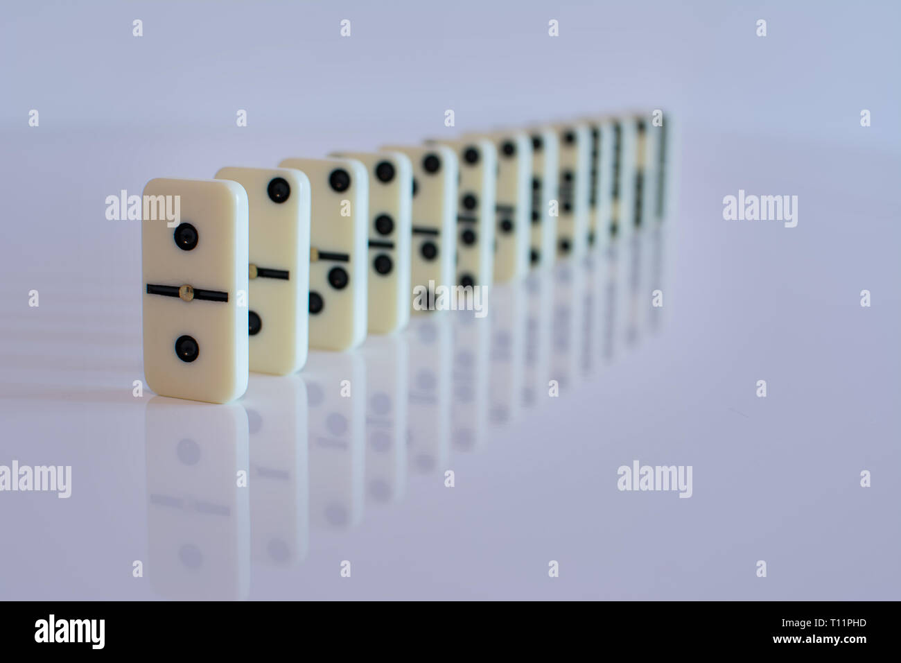 domino tiles in a row on white background in Low key Stock Photo - Alamy