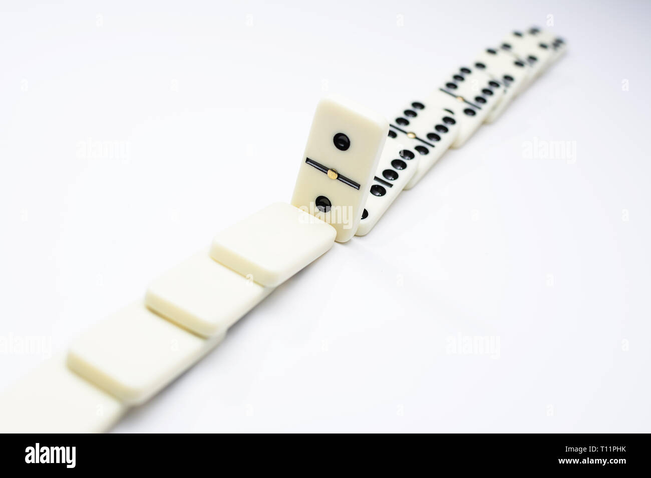 Dominoes falling in row hi-res stock photography and images - Alamy