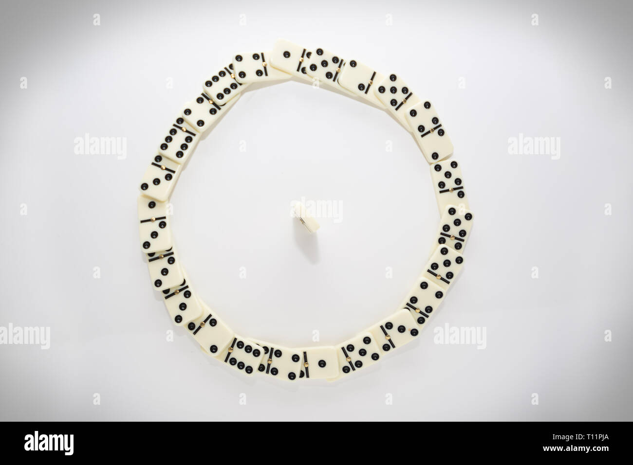 Concept of the leader with domino tiles falling in a circle and one ...