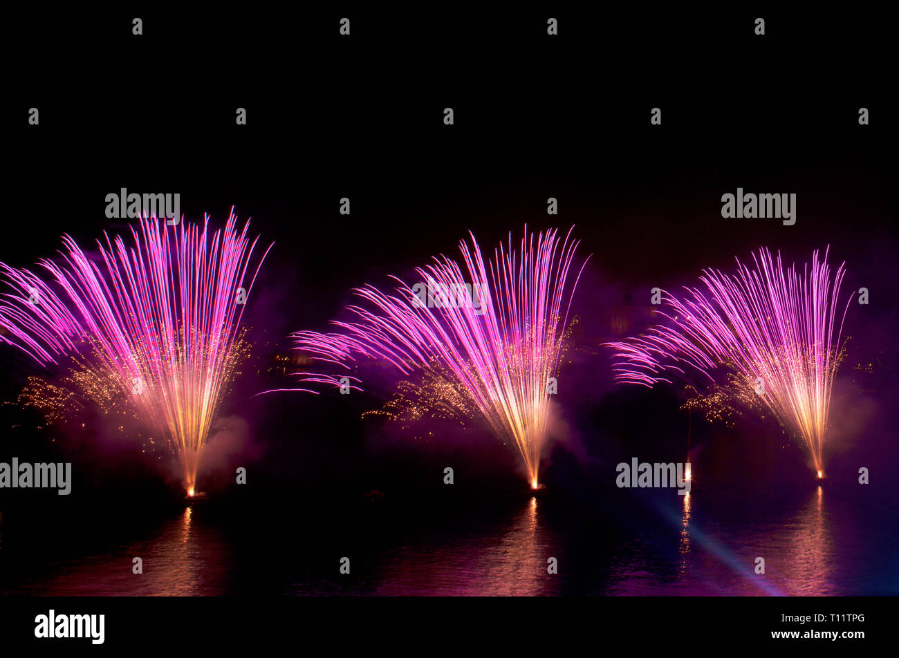 Violet fireworks isolated in dark background close up with the place ...