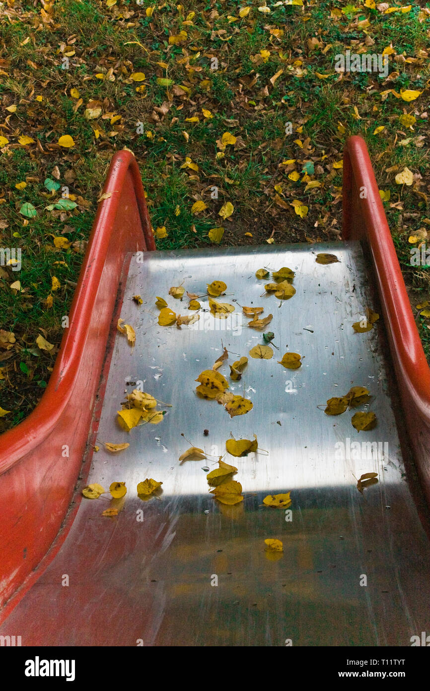 An old red slide on a playground Stock Photo - Alamy