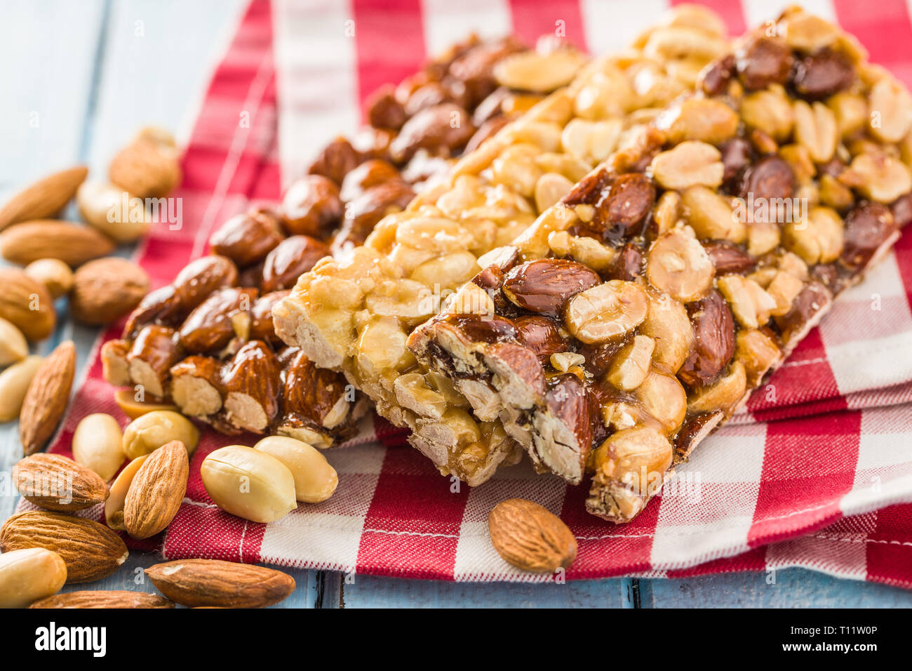Sweet nut bars with honey on checkered napkin Stock Photo - Alamy