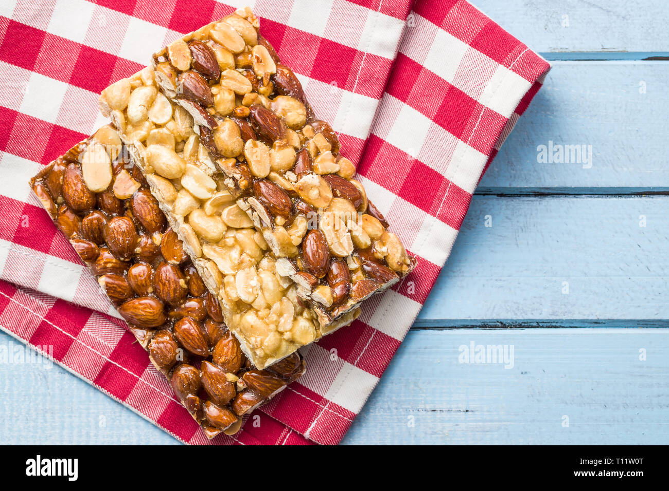 Sweet nut bars with honey on checkered napkin. Top view Stock Photo - Alamy