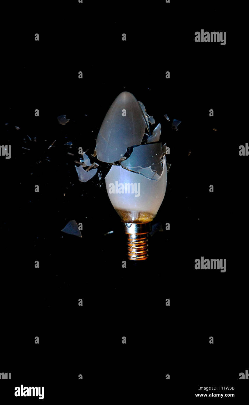 exploding lightbulb against black background Stock Photo - Alamy