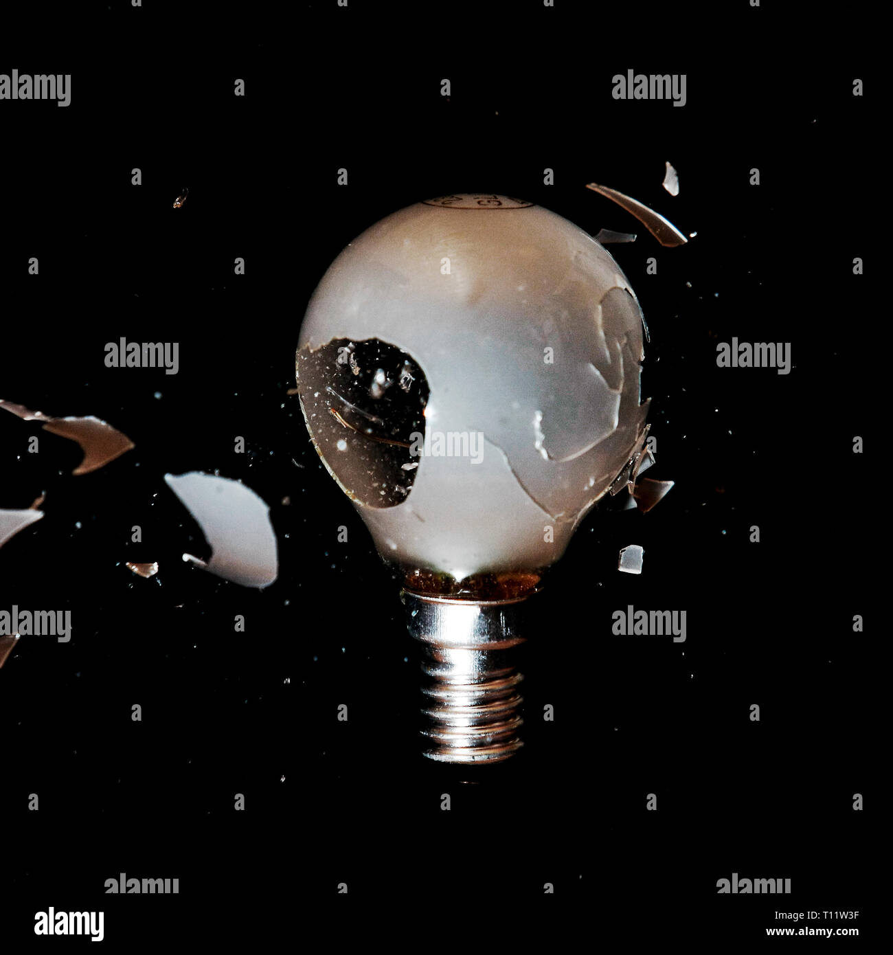 exploding lightbulb against black background Stock Photo - Alamy