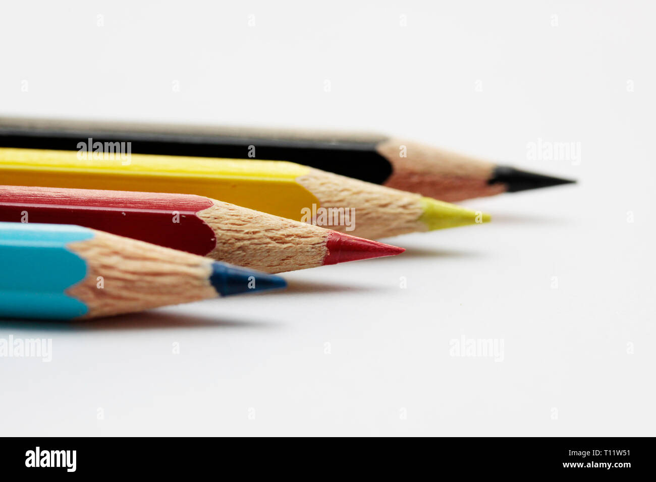 four pencils in the CMYK colours Stock Photo - Alamy