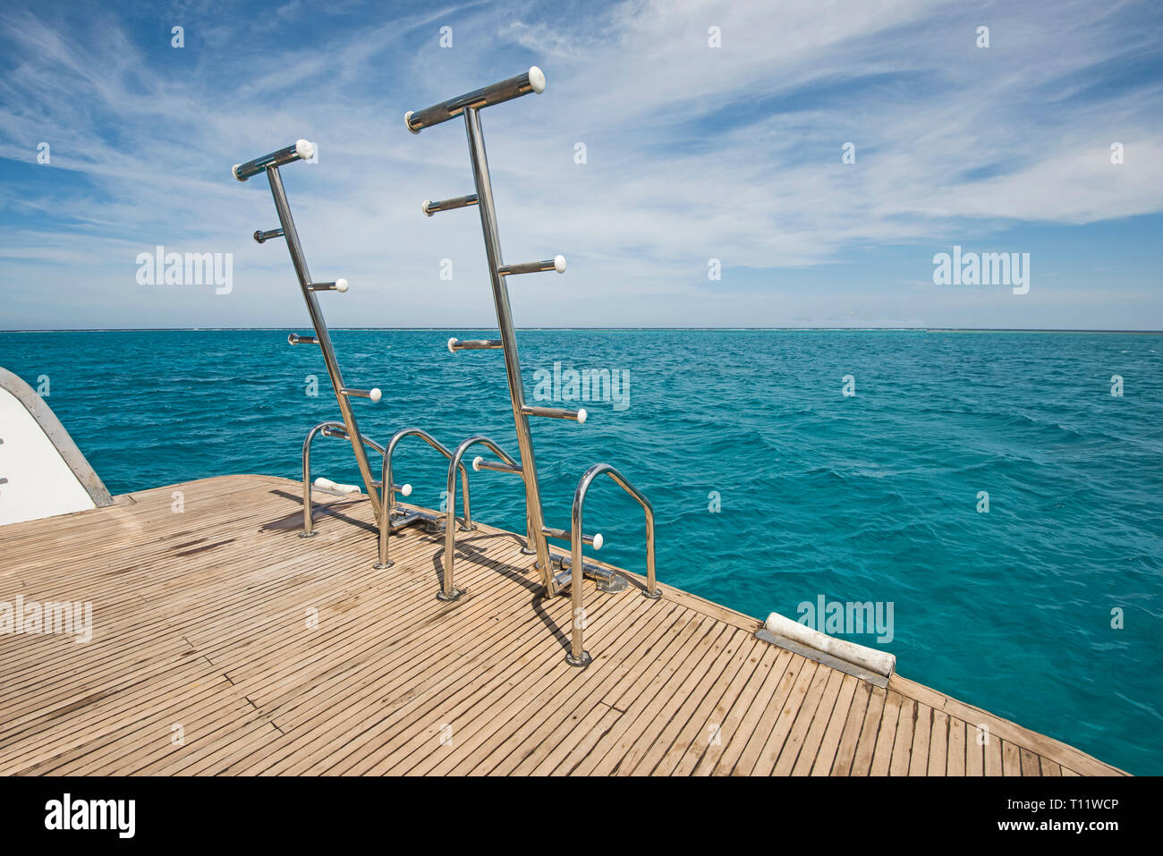Metal steel ladders on back teak deck of a luxury motor yacht sailing ...