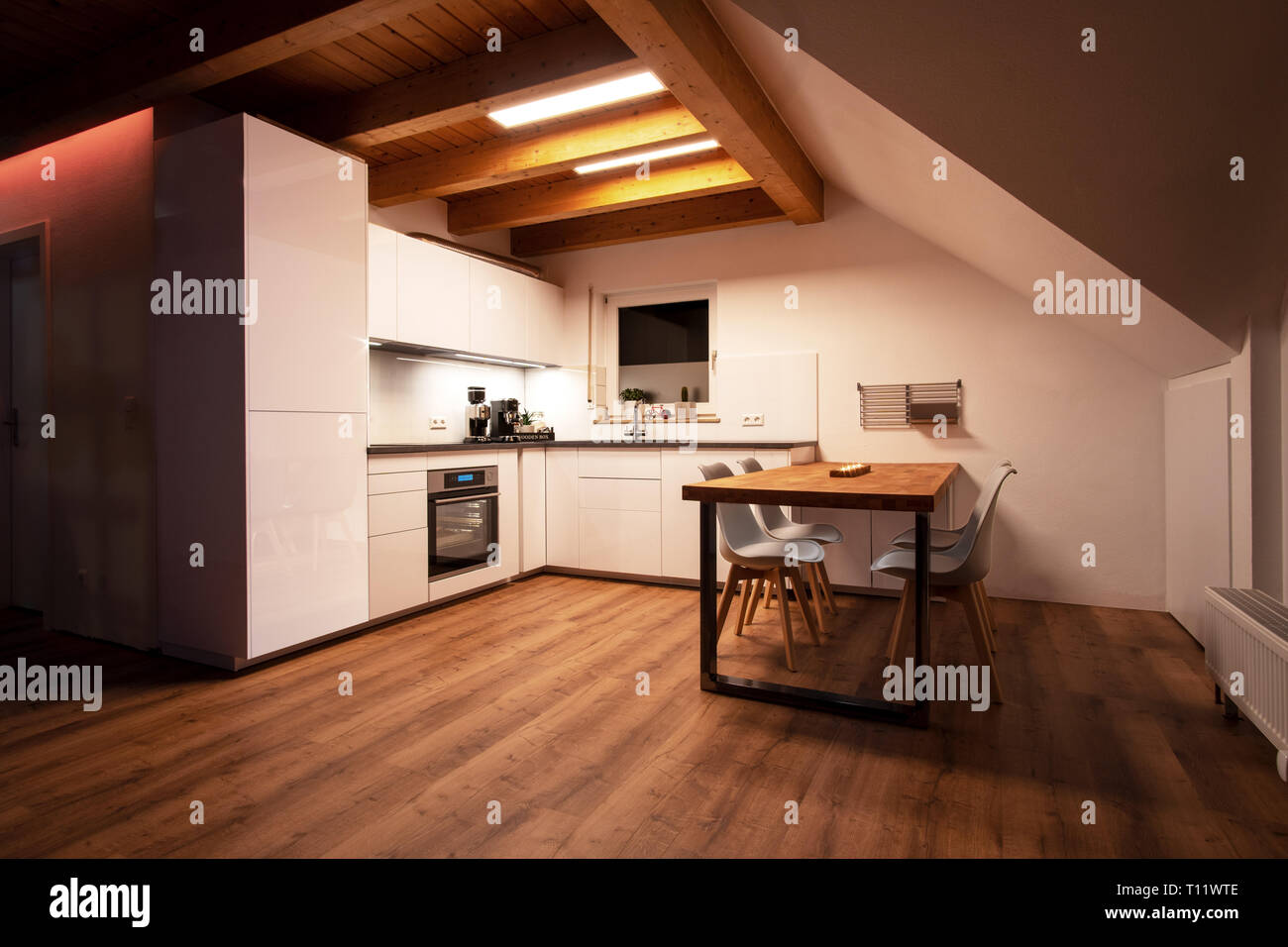 stylish kitchen with a lunch table Stock Photo - Alamy