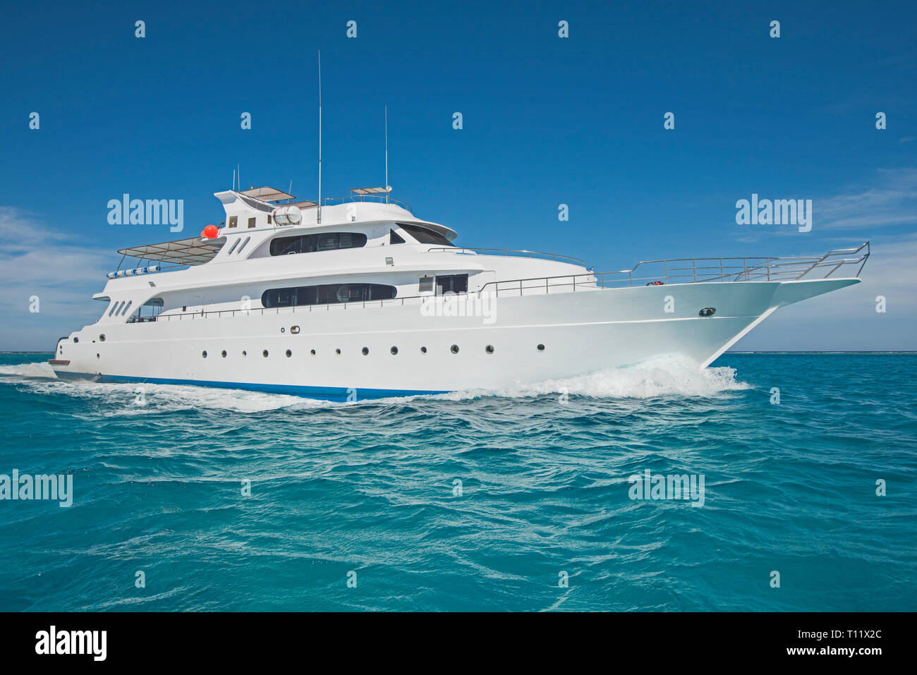 Large luxury motor yacht under way sailing out on tropical sea ocean ...