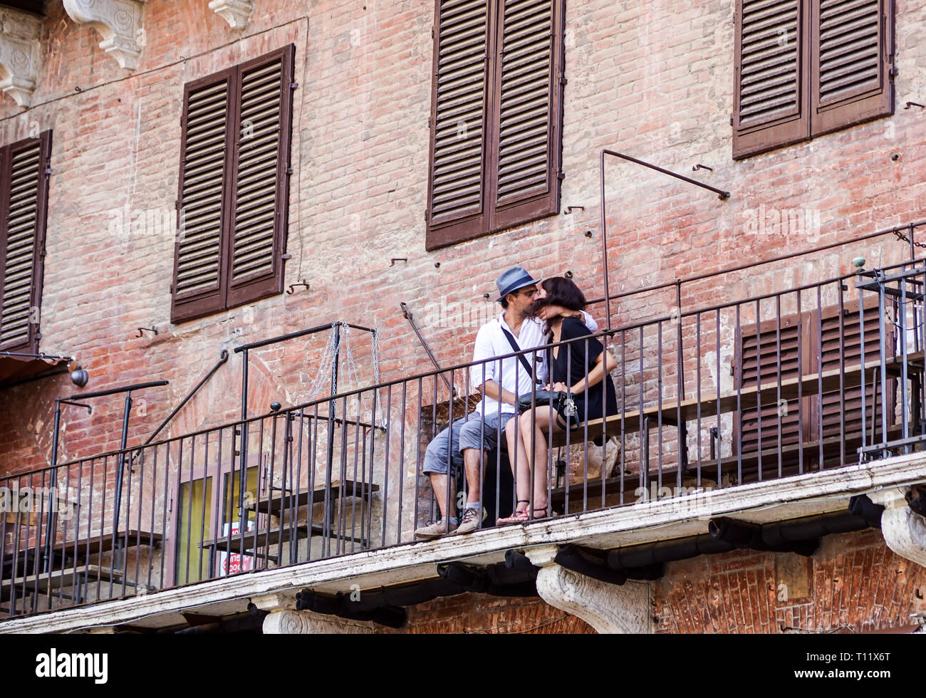 Siena , Italy 18 July 2018 : Romantic couple . a couple kisses in a ...