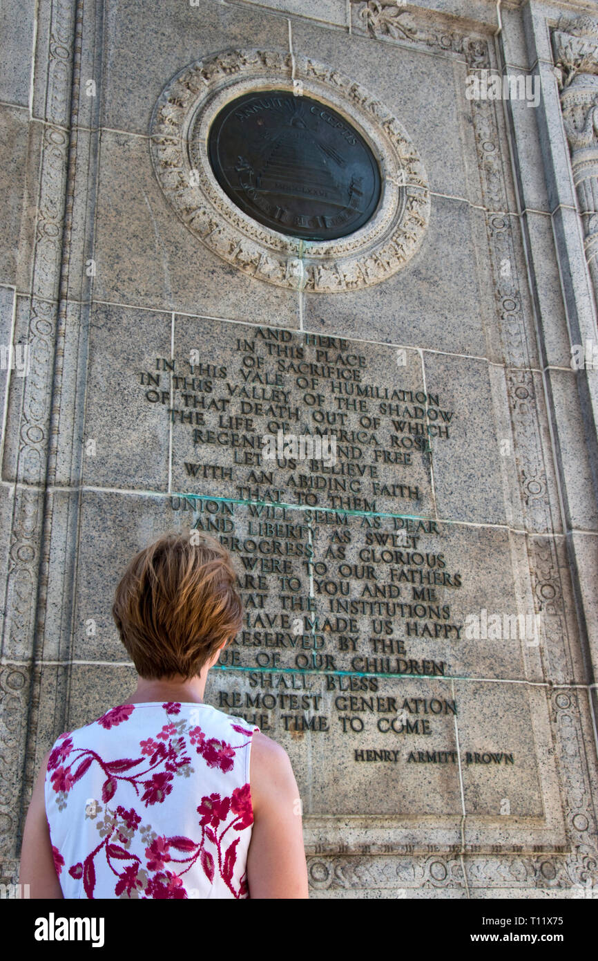 A woman reads the inscription on the National Memorial Arch, dedicated ...
