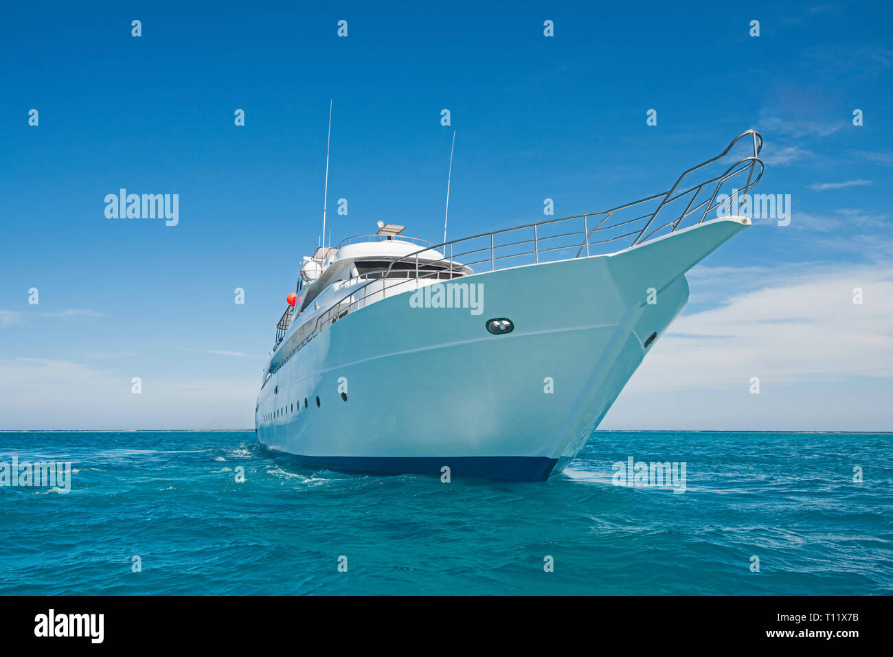 Large luxury motor yacht under way sailing out on tropical sea ocean ...