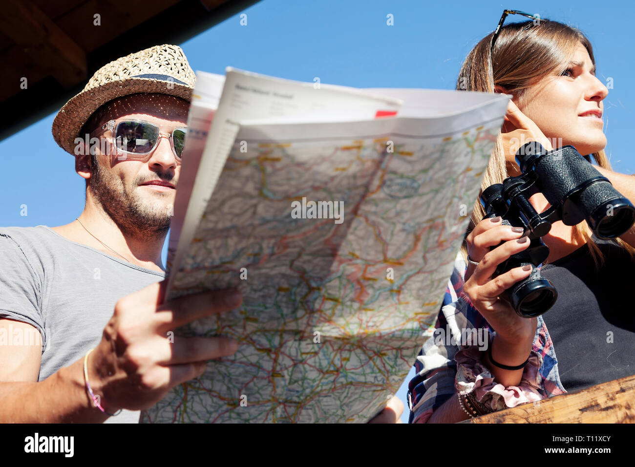 group of young hikers looking at map in the mountain Stock Photo - Alamy