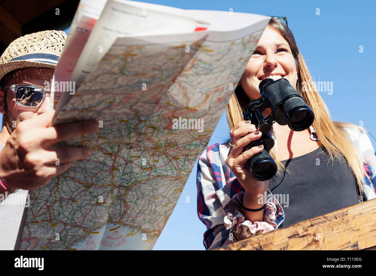 group of young hikers looking at map in the mountain Stock Photo - Alamy