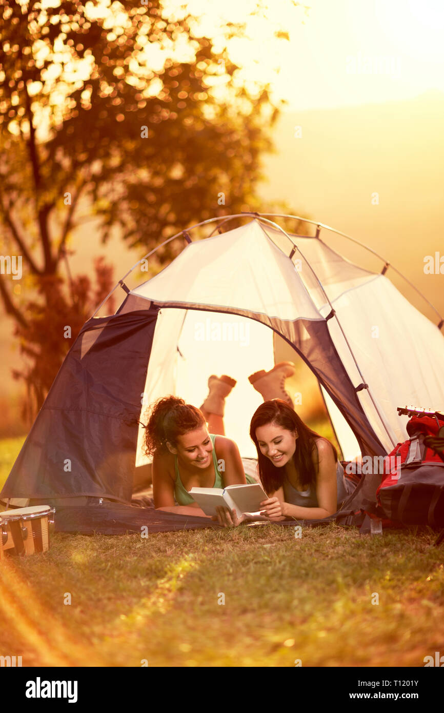 Two student girls enjoying in camping trip in countryside Stock Photo ...