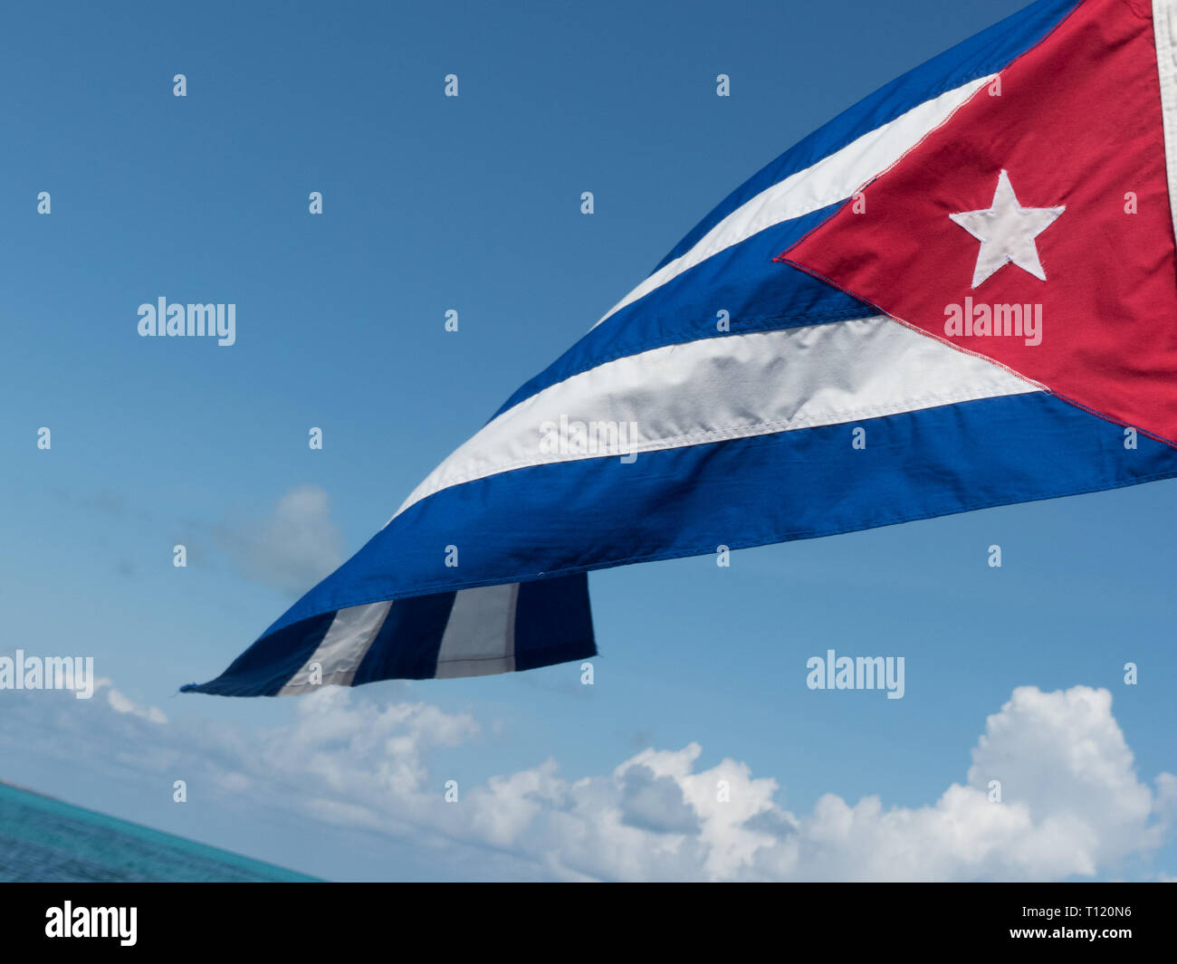 Cuba national flag closeup blue sky background Stock Photo - Alamy