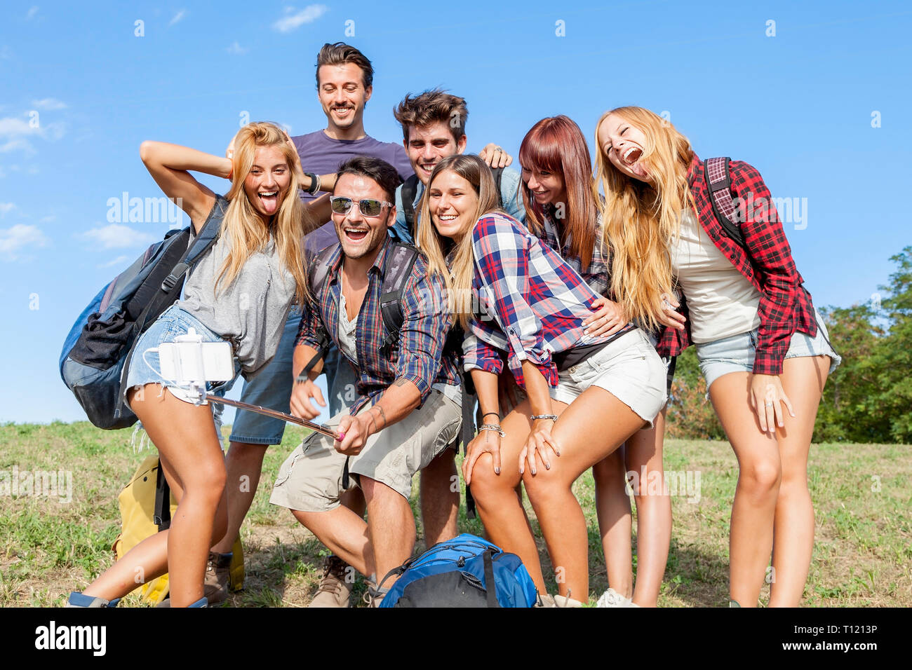 group of friends taking a self portrait with selfie stick Stock Photo ...