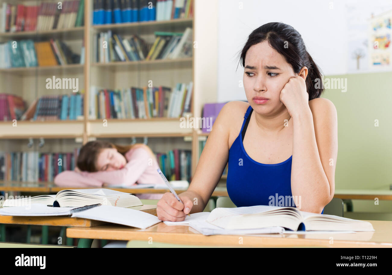 Female teenager alone in class hi-res stock photography and images - Alamy