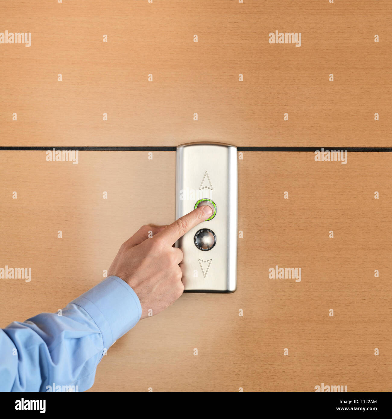 Clerk pressing the button and calling the elevator going up Stock Photo ...