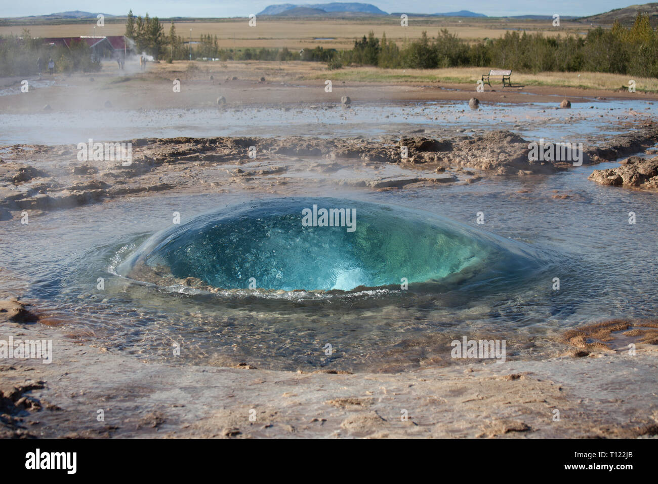 The turquoise blue boiling bubble of Strokkur Geyser In Iceland before ...