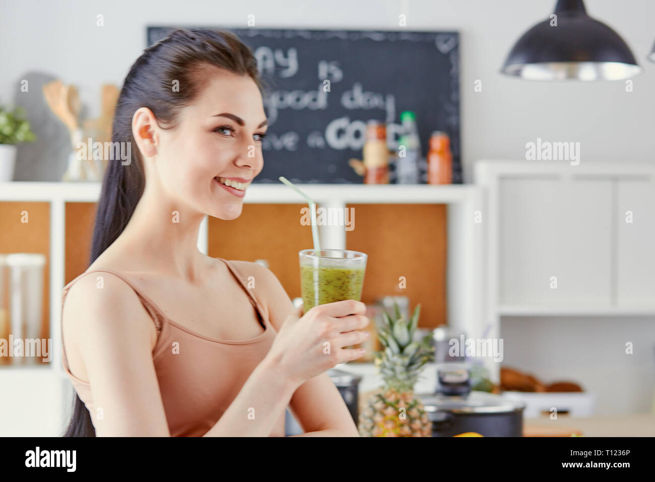 a young girl drinks a cocktail on a kitchen Stock Photo - Alamy