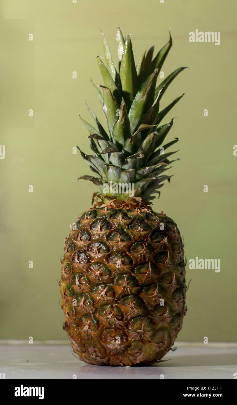 pineapple cut in different shapes with green background and splash of ...