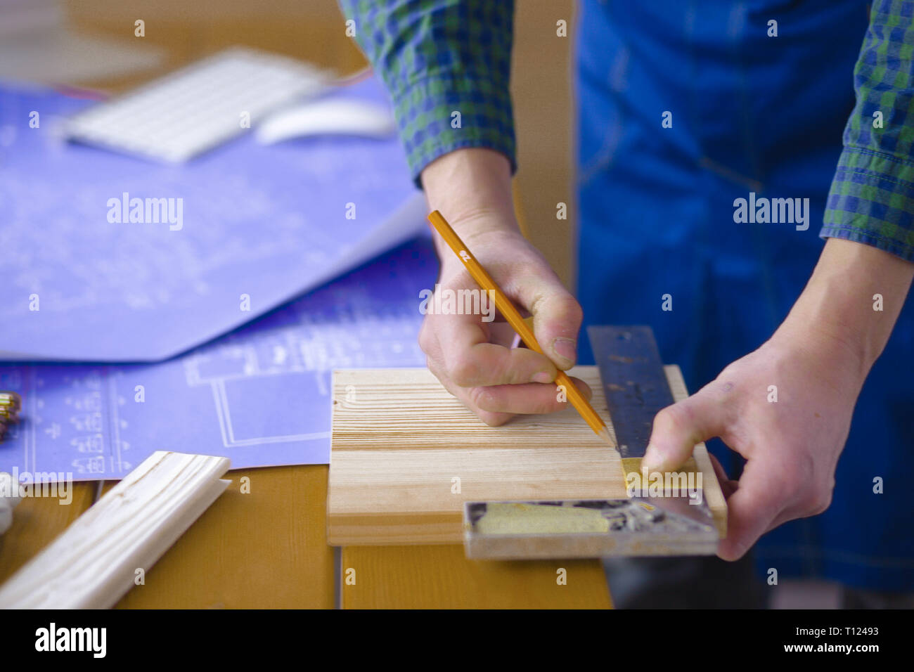 Engineer carpenter working on laptop and sketching project Stock Photo ...