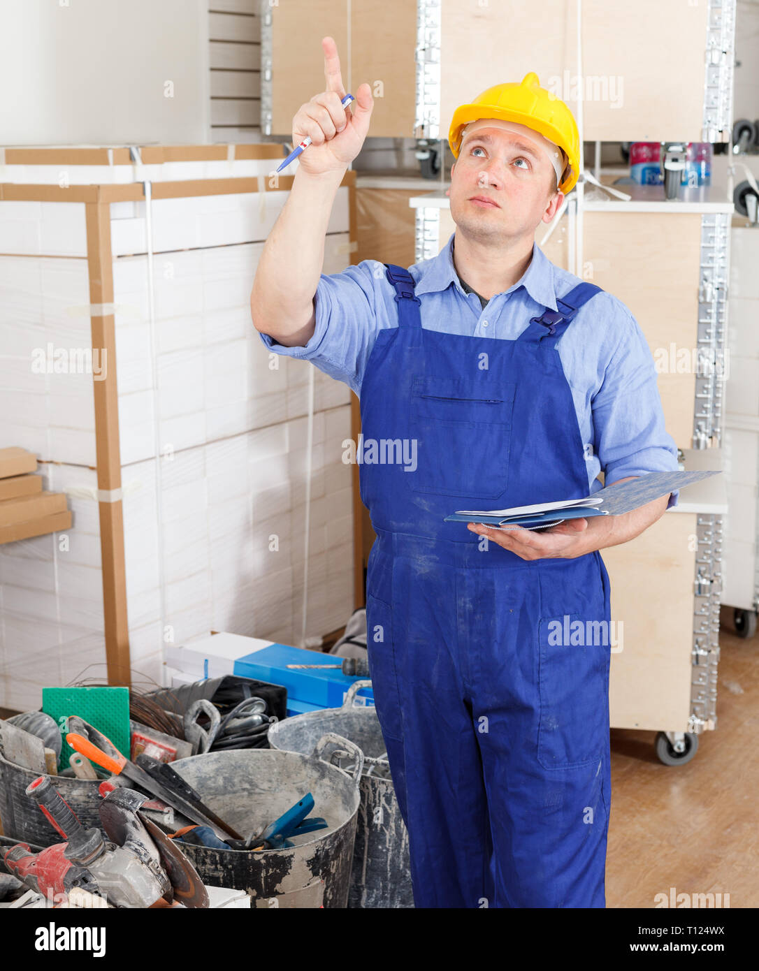 Confident builder handyman examining room and planning construction ...