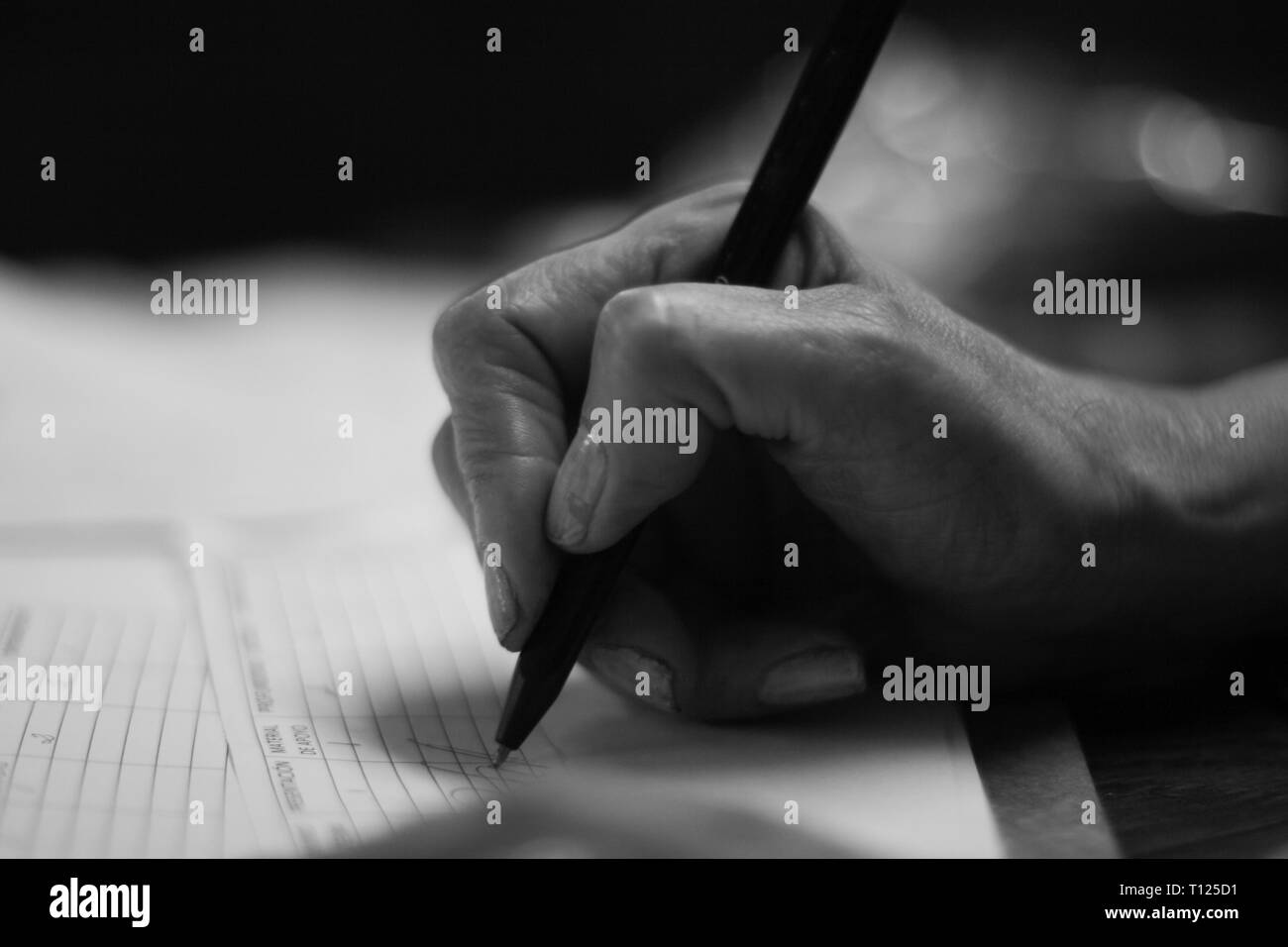 Teacher writing some notes in a gloomy classroom Caracas Venezuela ...