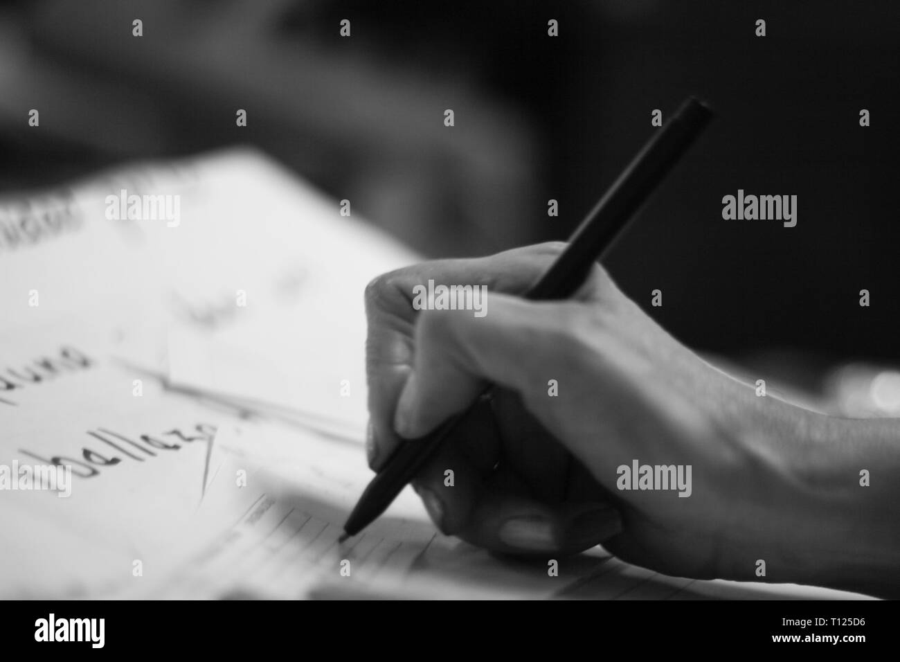 Teacher writing some notes in a gloomy classroom Caracas Venezuela ...