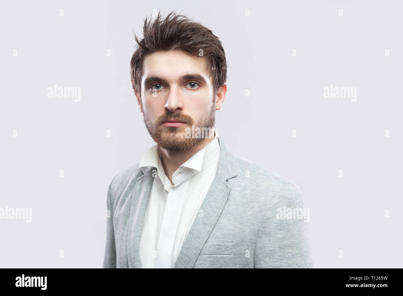 Portrait of handsome bearded serious man with brown hairs and beard in ...