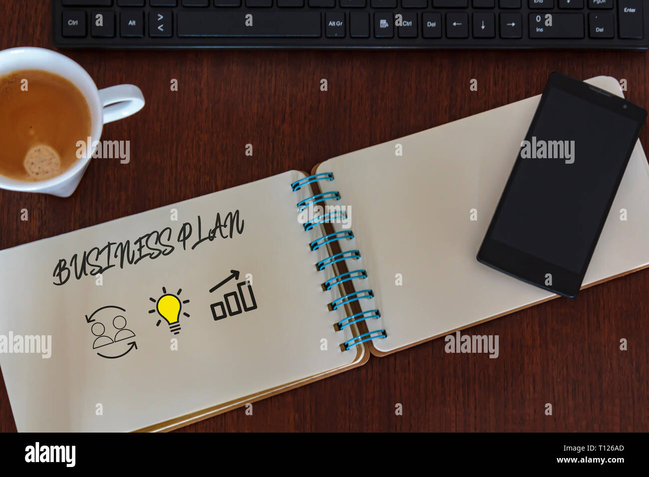 Top view of desk table with notebook with business plan. Teamwork and ...