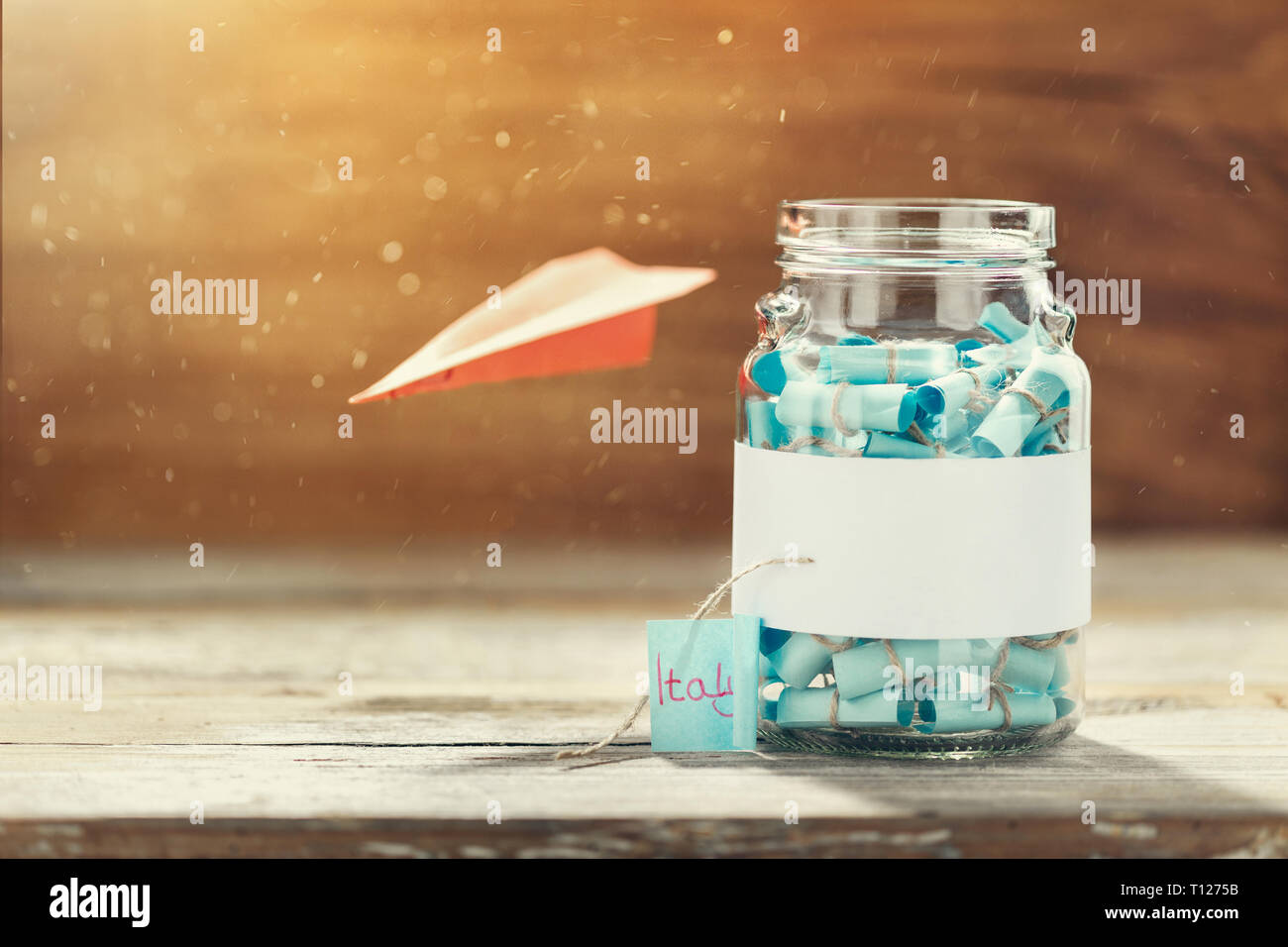 Glass jar with list of countries to visit and paper airplane. Creative ...