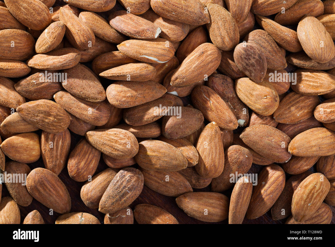 Closeup of shelled roasted almonds as background. Concept of healthy ...