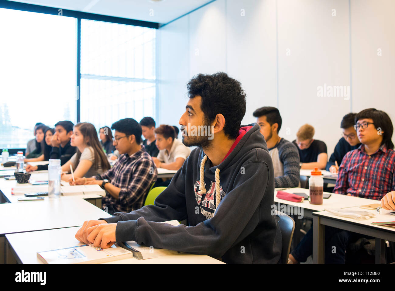 A busy classroom full of multicultural students during a lesson Stock ...