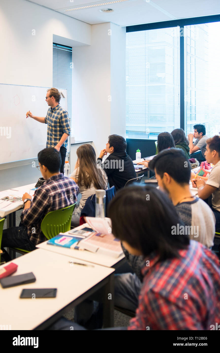A busy classroom full of multicultural students during a lesson Stock ...