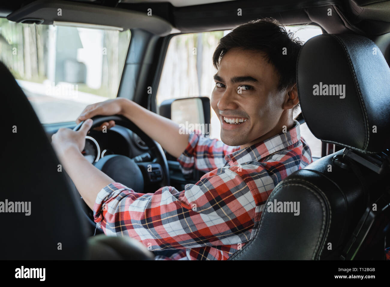 male driver looking at the back Stock Photo - Alamy