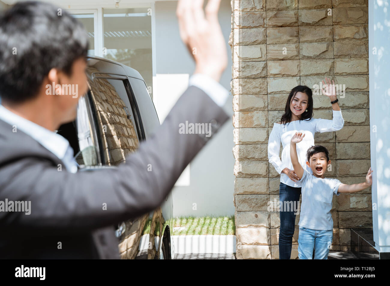 father waving goodbye to his family before going to work Stock Photo ...